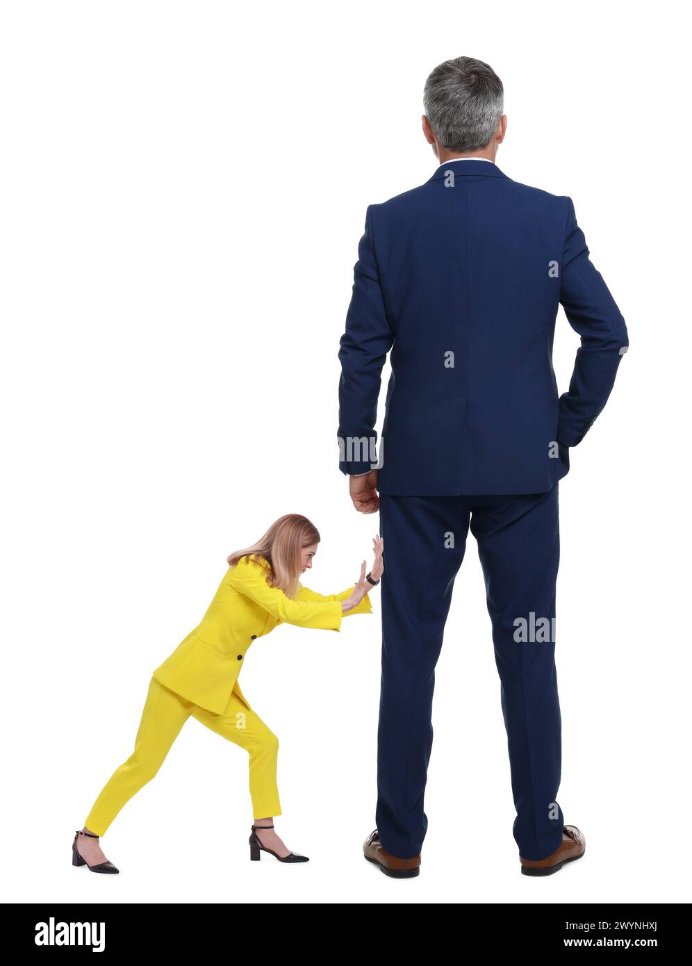 Small woman pushing giant man on white background Stock Photo - Alamy