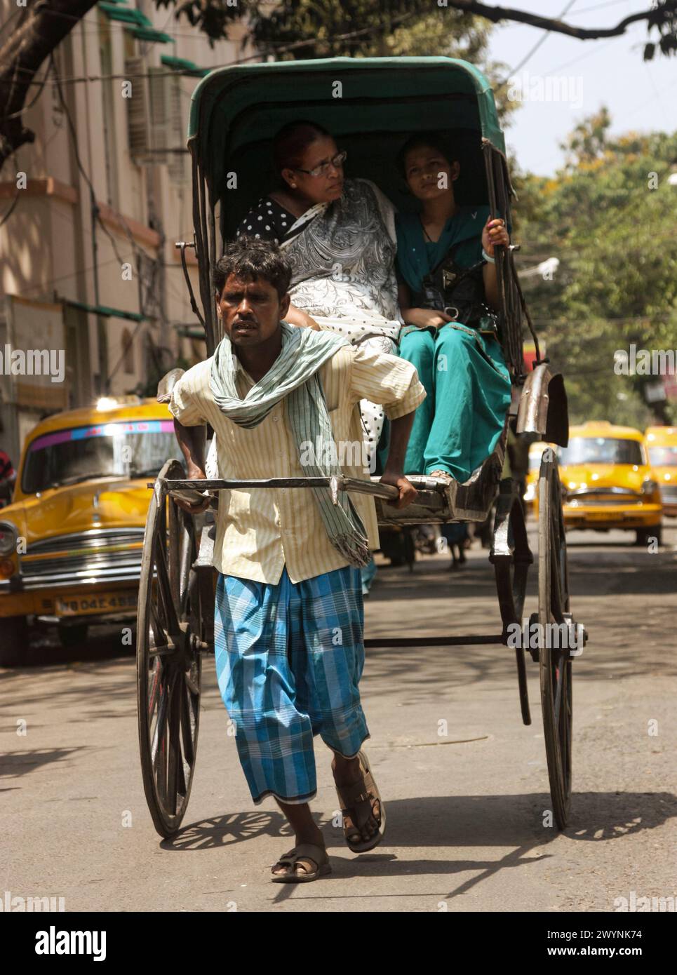 Kolkata rickshaw wallahs with passengers. Kolkata is among the only ...