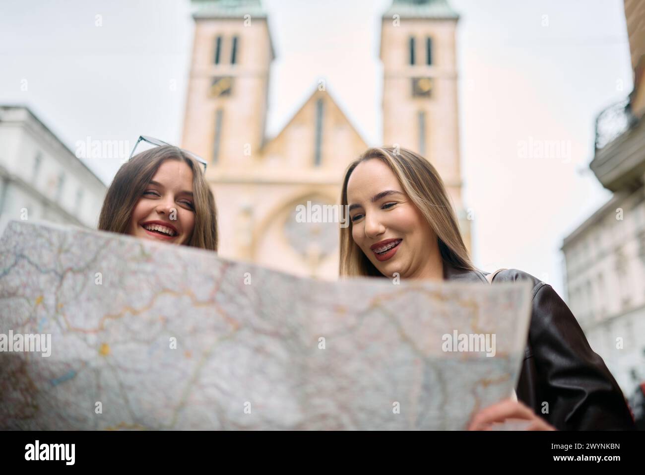 Two female tourists engage in lively discussion, surrounded by their ...