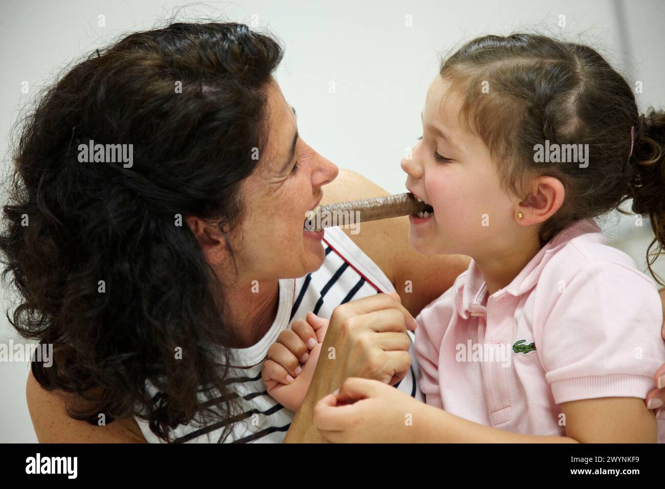 Mother and daughter eating a chocolate bar, tasting session in sensory ...