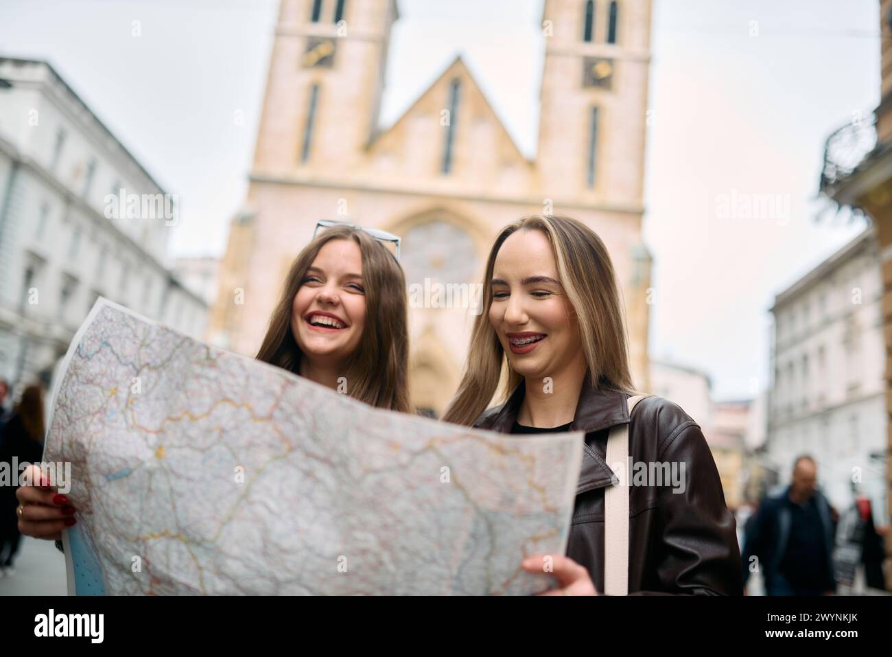 Two female tourists engage in lively discussion, surrounded by their ...