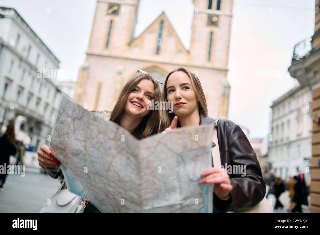 Two female tourists engage in lively discussion, surrounded by their ...