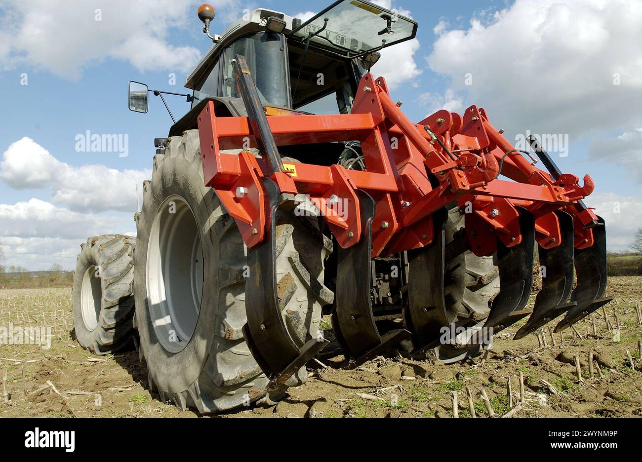 Tractor with plow at field Stock Photo - Alamy