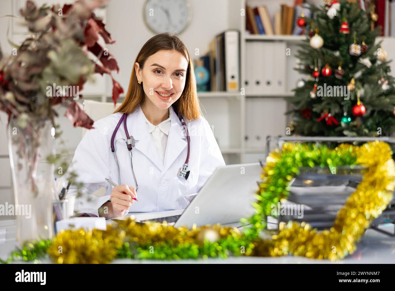 Physician woman in decorated office during christmas Stock Photo - Alamy