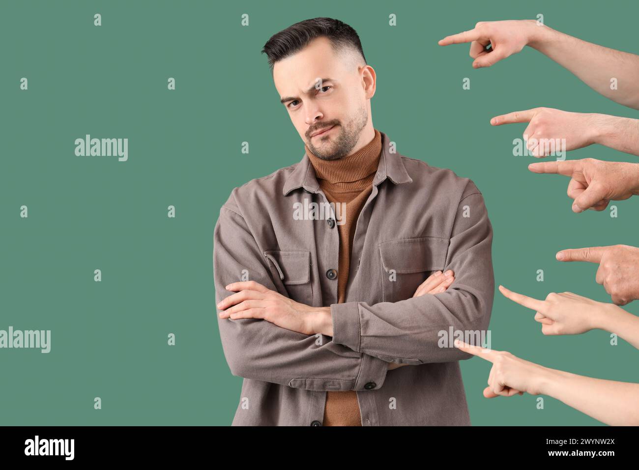 People pointing at young man on green background. Accusation concept ...