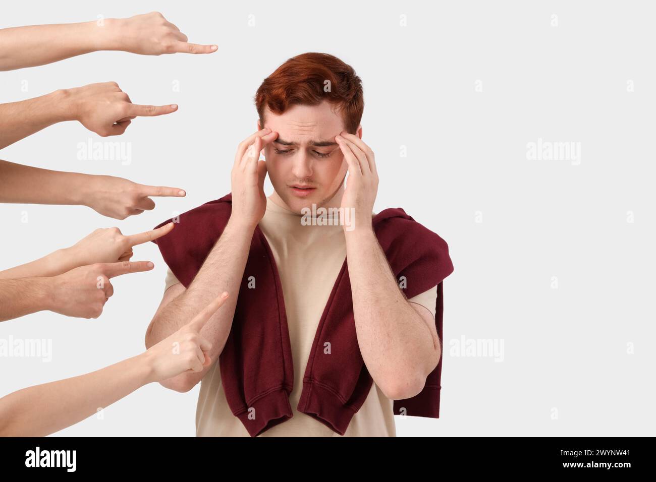 People pointing at stressed young man on white background. Accusation ...