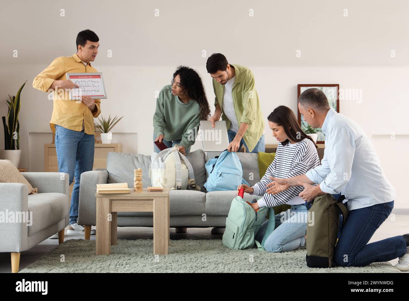 People with evacuation plan packing things indoors Stock Photo - Alamy