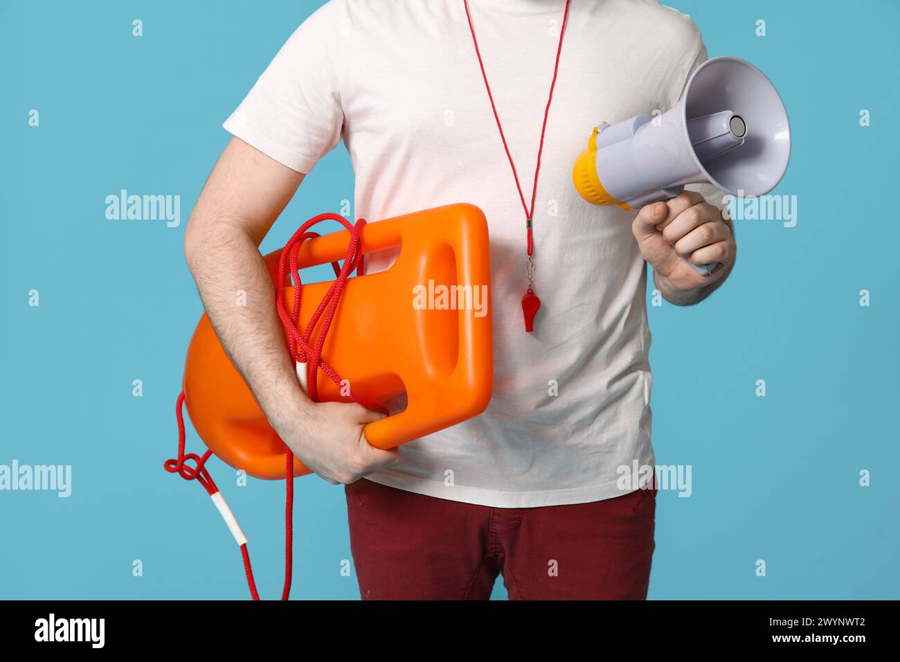 Male lifeguard with rescue tube buoy and megaphone on blue background ...