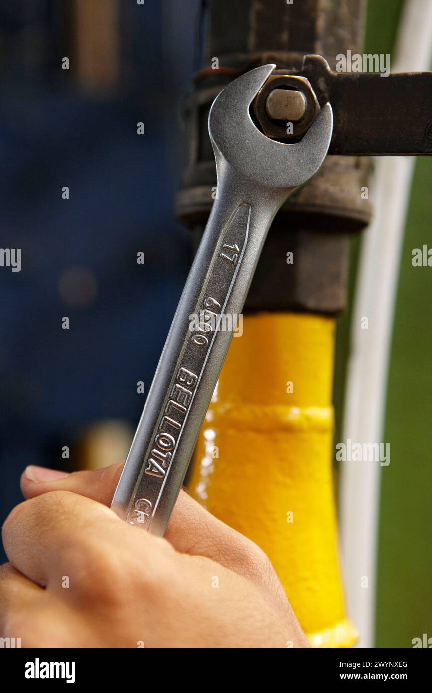Worker using wrench, industrial maintenance Stock Photo - Alamy