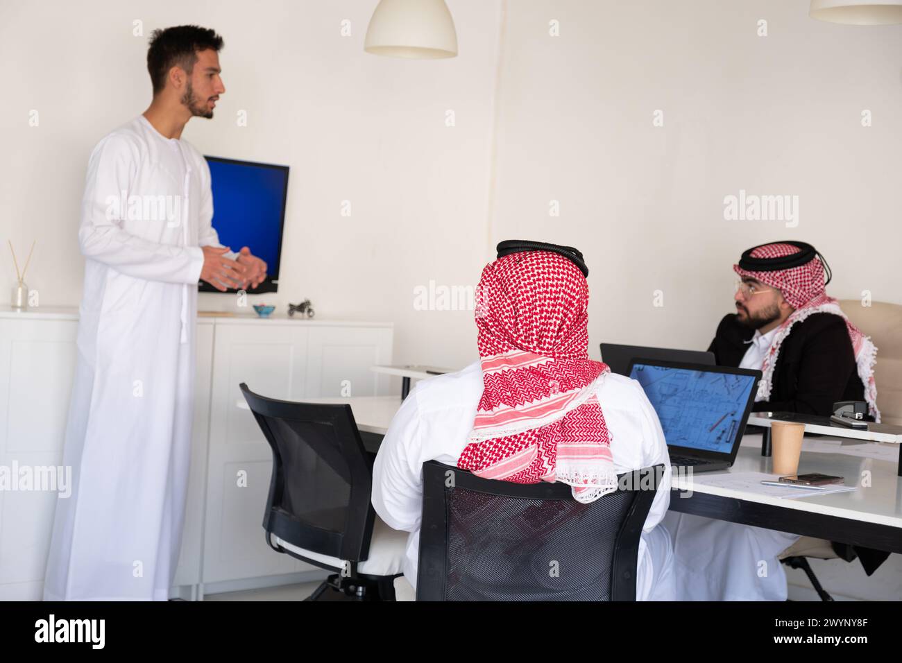 arab using laptop during work in office on meeting table to finish the ...