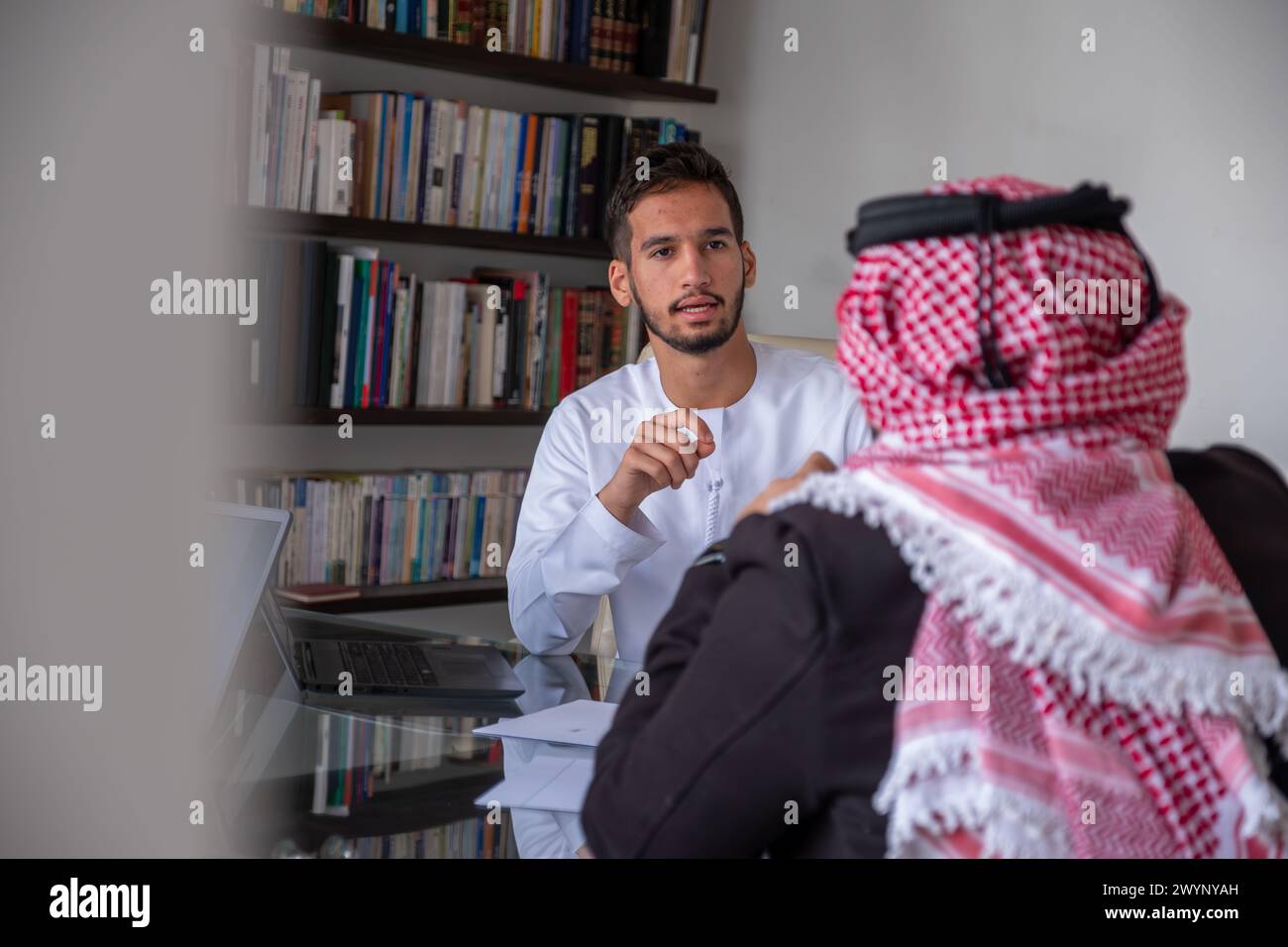 Arab talking while working on their project Stock Photo - Alamy