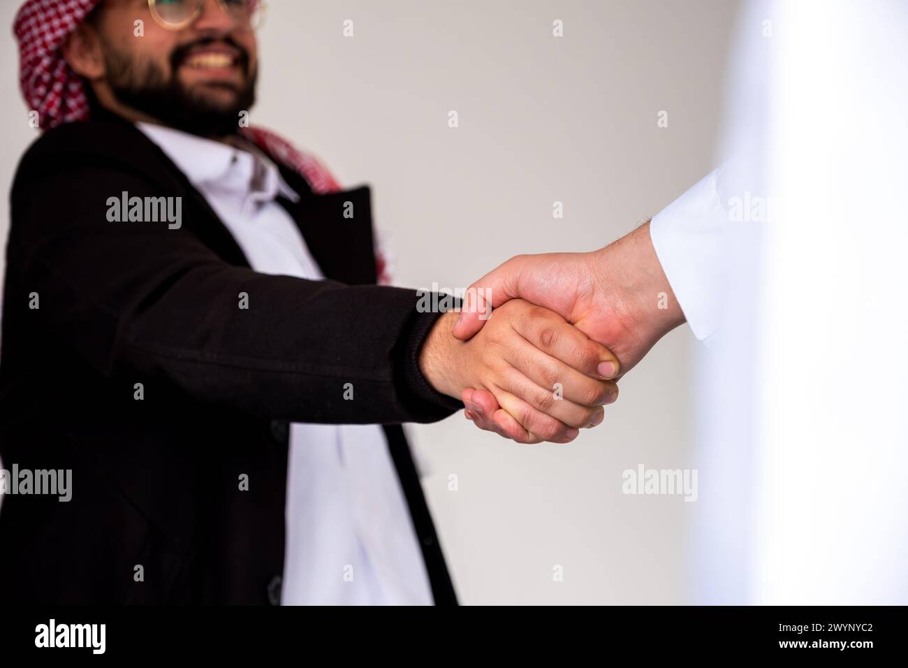 Arab shaking hands friendly and lovely Stock Photo - Alamy