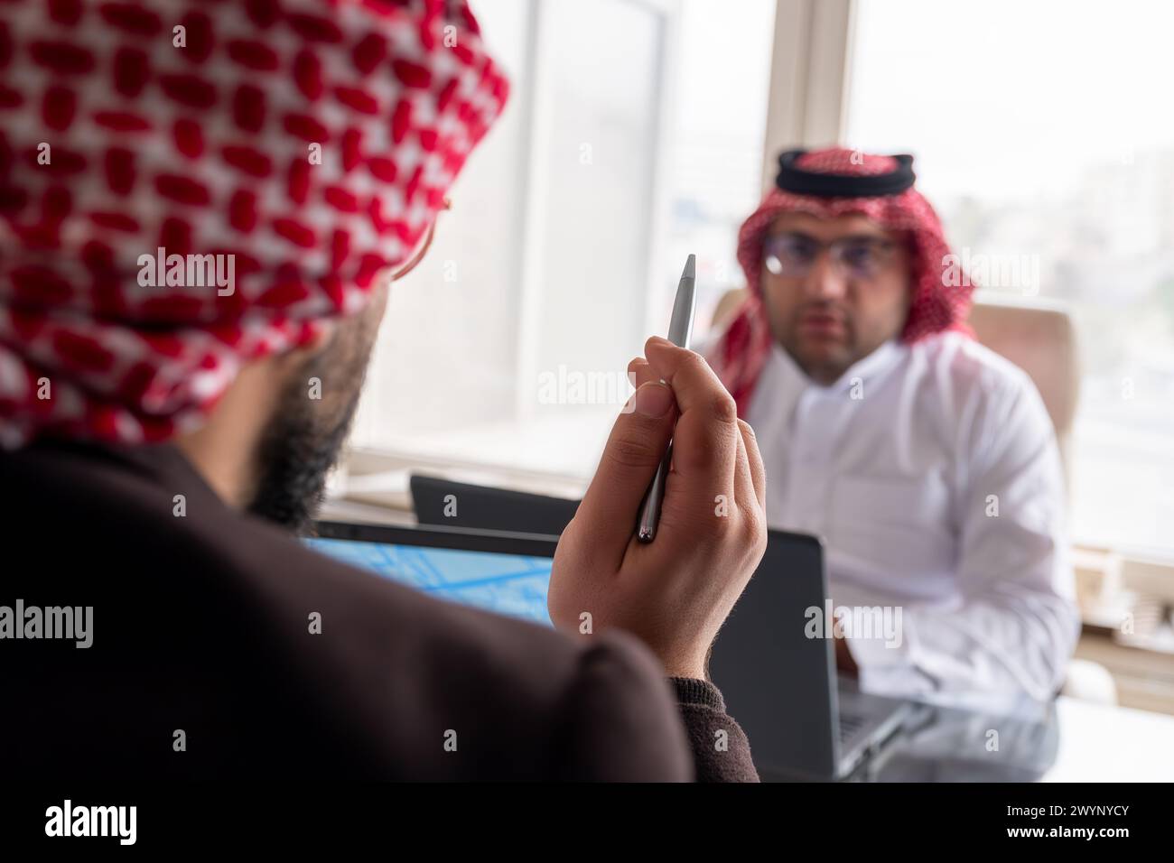 meeting between two arabs talking about work details Stock Photo - Alamy