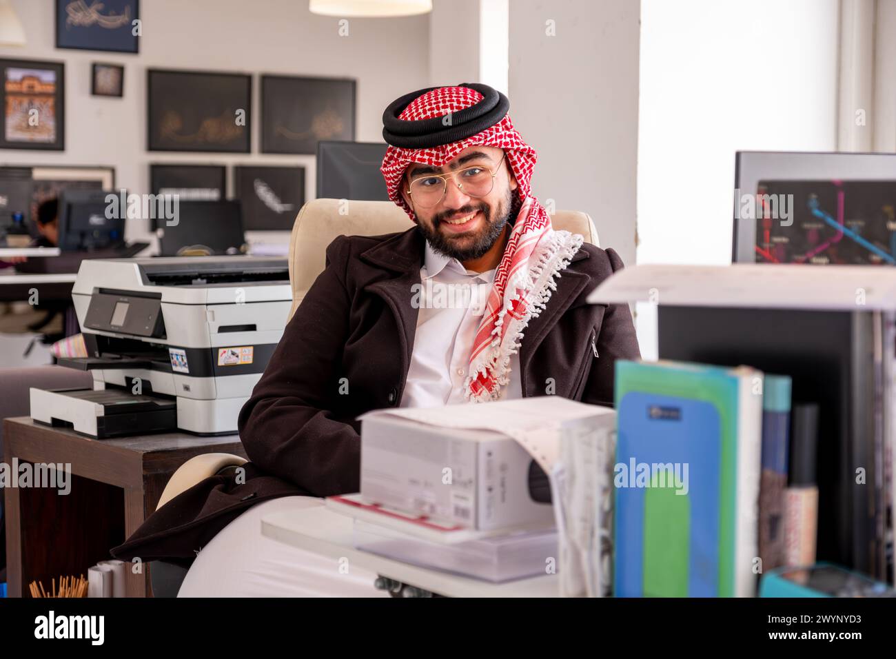 In an elegant office setting, an Arabic gentleman sits comfortably in ...