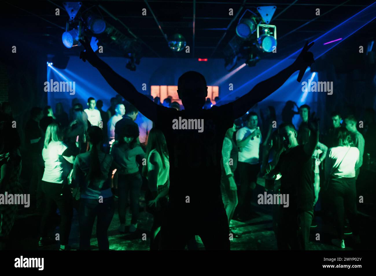 mc with microphone on the night club scene on the background of blurred ...