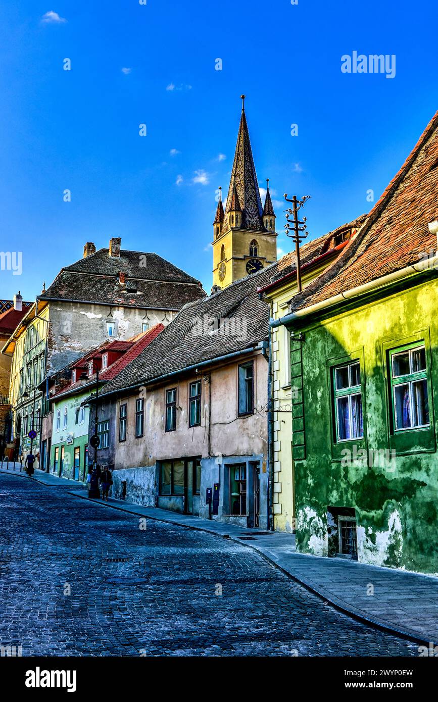 Houses with eyes lining Strada Ocnei and top of the clock tower of the ...