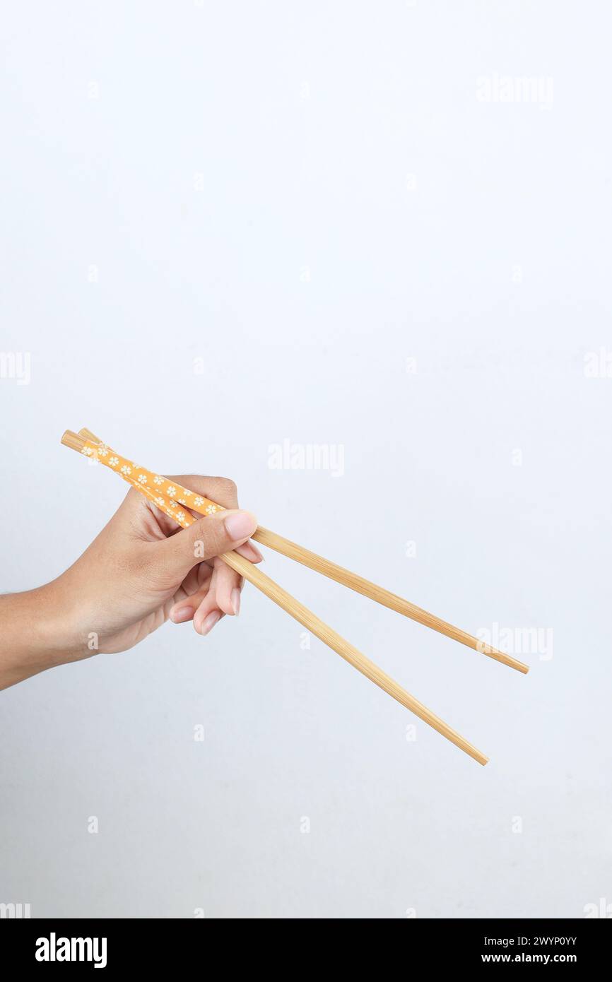 Female Hand Holding Chopstick on White Background Stock Photo - Alamy