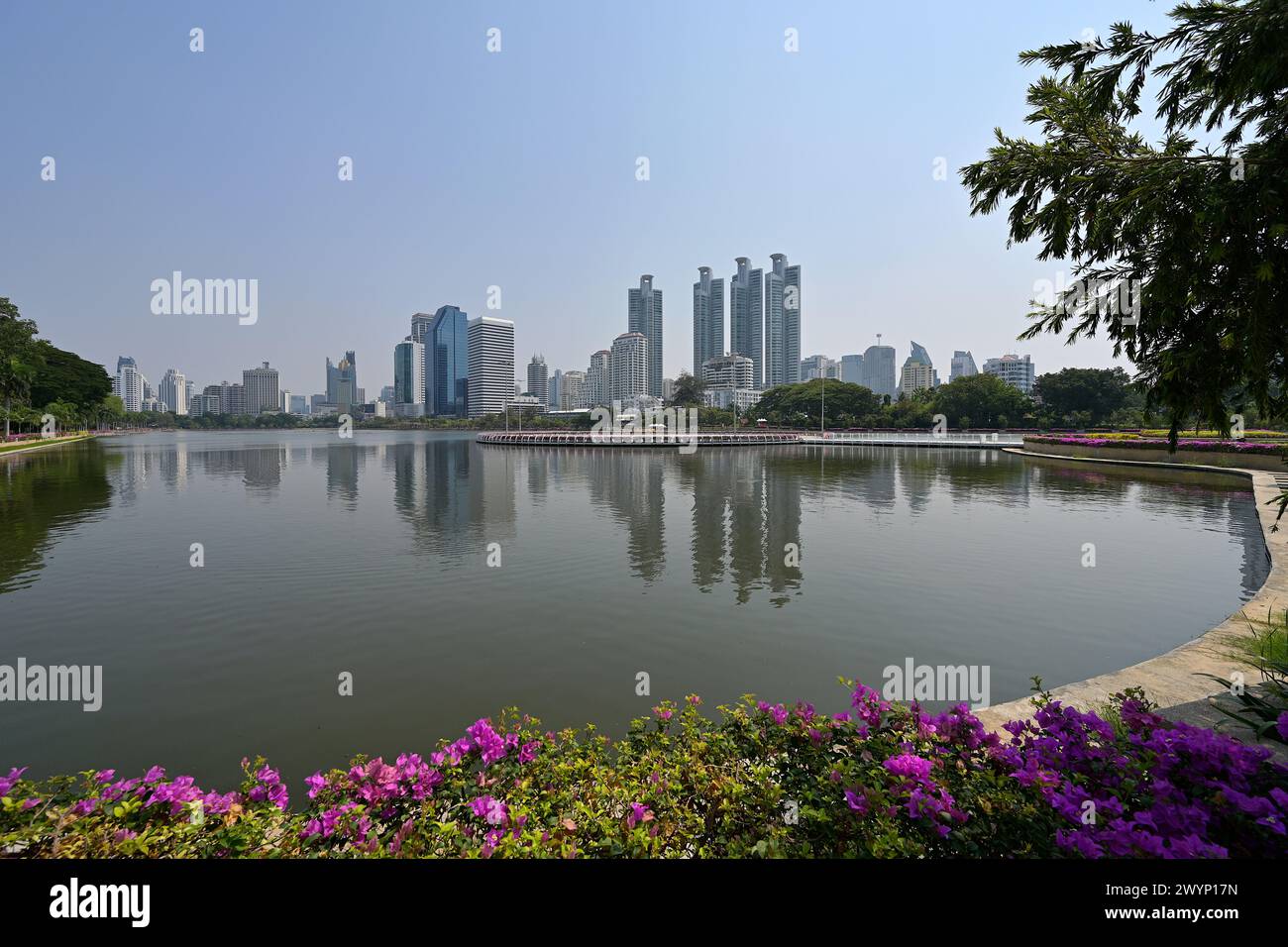 View of Lake Ratchada at Benjakitti Park, Bangkok, with skyscrapers of ...