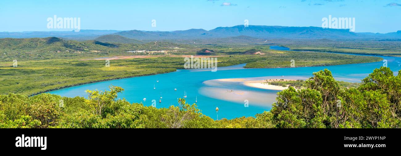 A panoramic image of boats anchored beside the massive mangrove forest ...