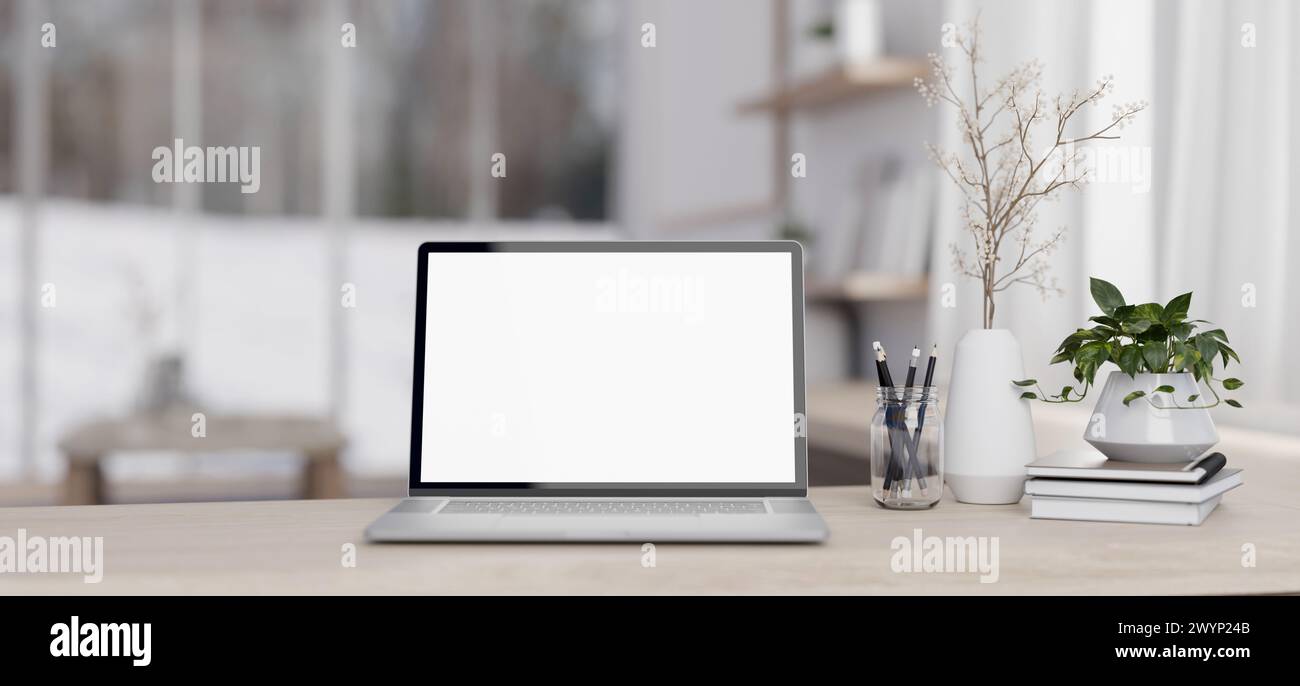 A white-screen laptop computer mockup and decor on a minimal wood table ...