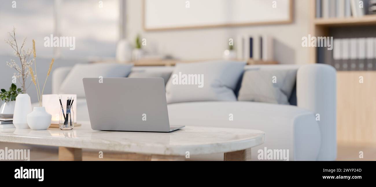 A laptop computer on a luxury white marble coffee table in a ...