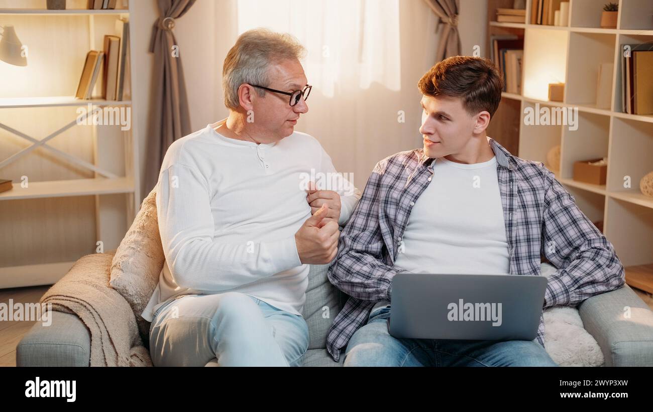 Parent help. Laptop lesson. Digital technology. Supportive father teaching son use internet ...