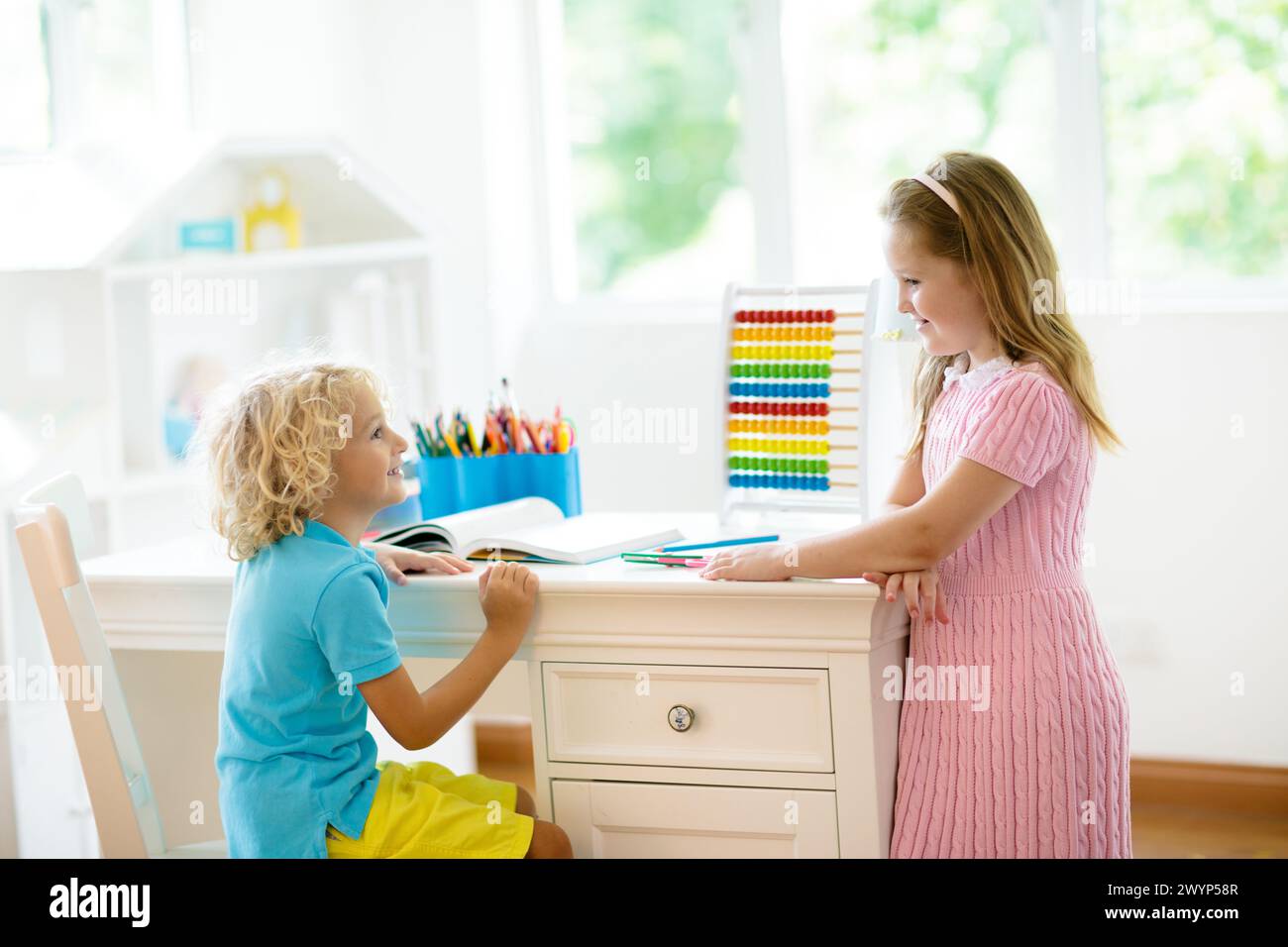 Child drawing rainbow. Kid painting at home. Little girl and boy doing ...