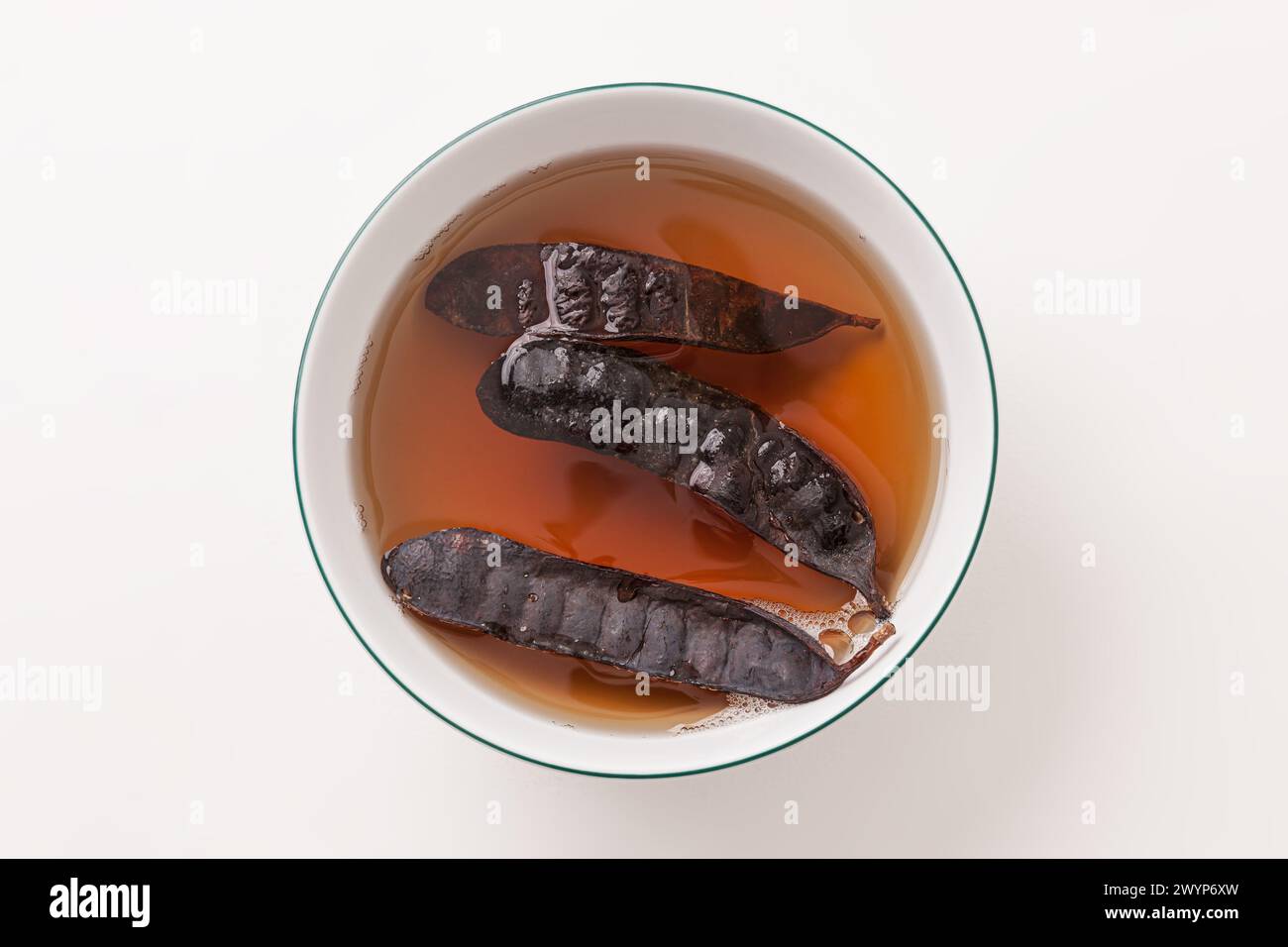 The dried Gleditsia fruit or Thorny Honey Locust are soaked in a bowl ...