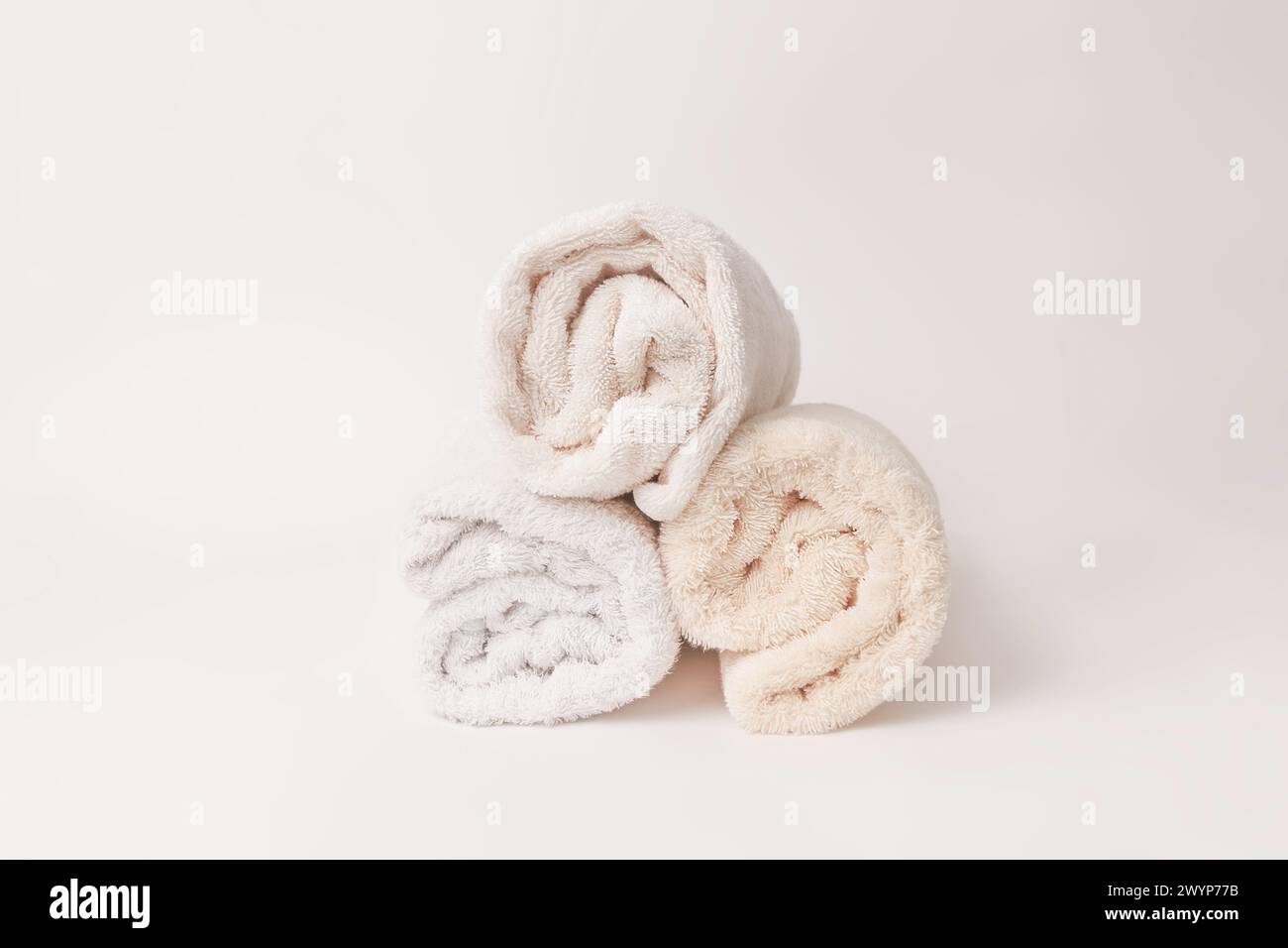 Clean rolled beige soft bath towels stack on a white background Stock ...