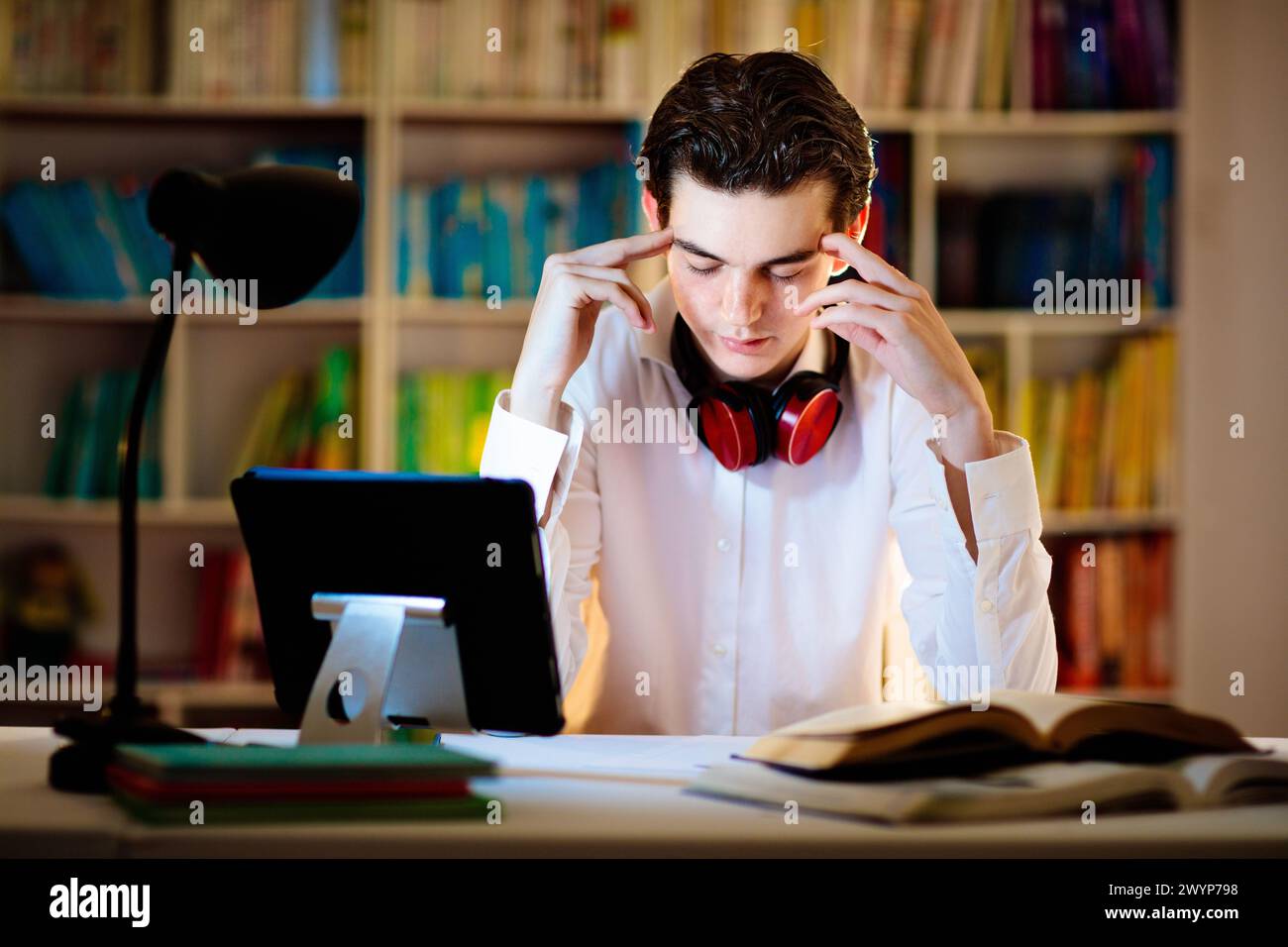Teenage student at laptop. Online remote learning in high school or ...