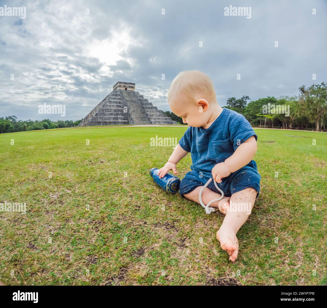 Baby traveler, tourists observing the old pyramid and temple of the ...