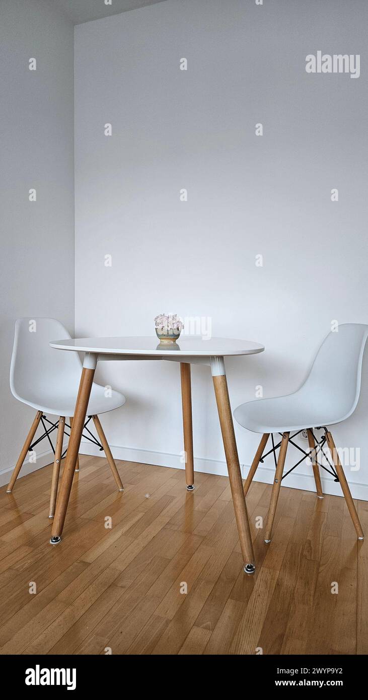 round table in interior with parquet floor and white wall Stock Photo ...