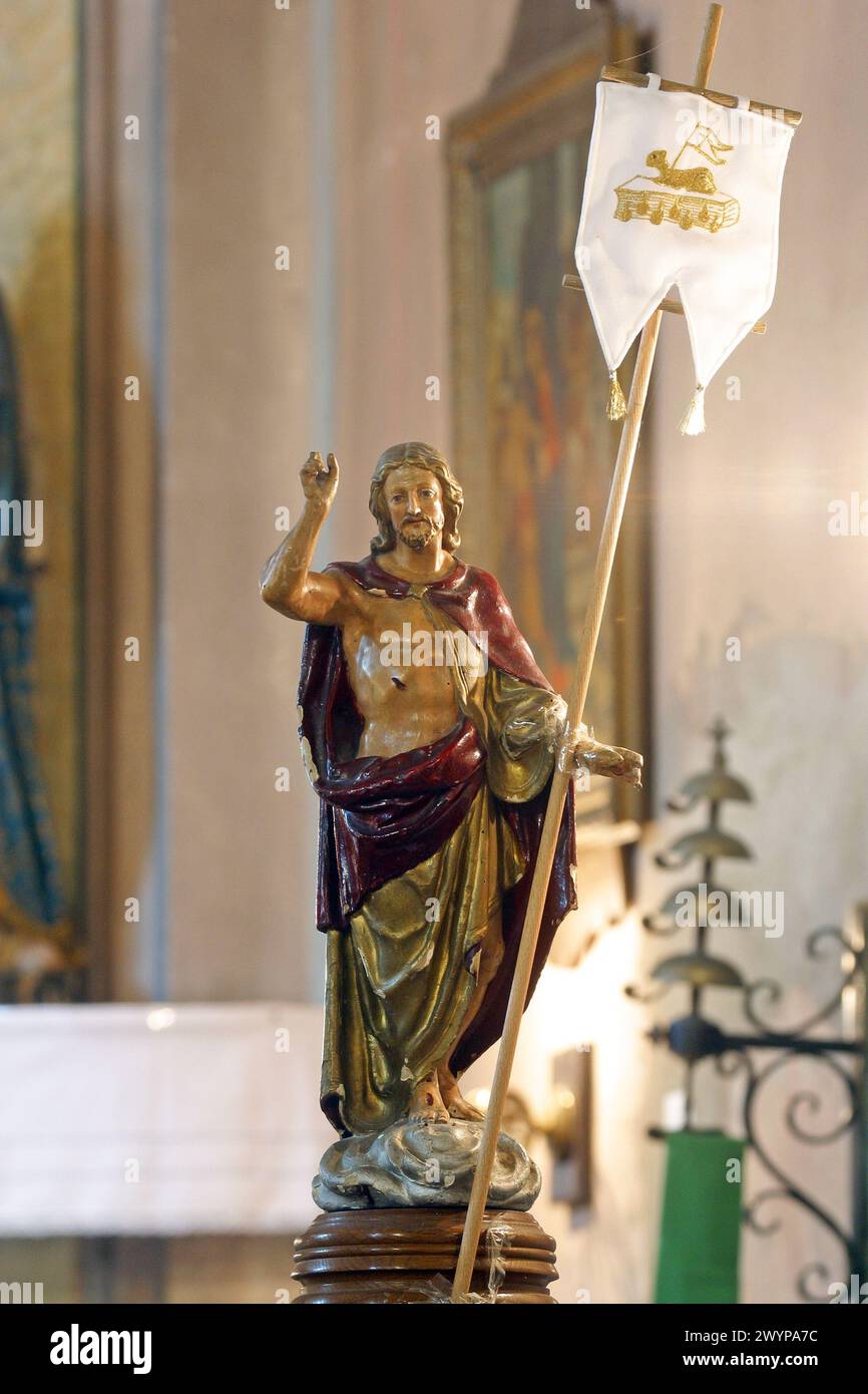 The Risen Christ, statue on the baptismal font in the parish church of ...