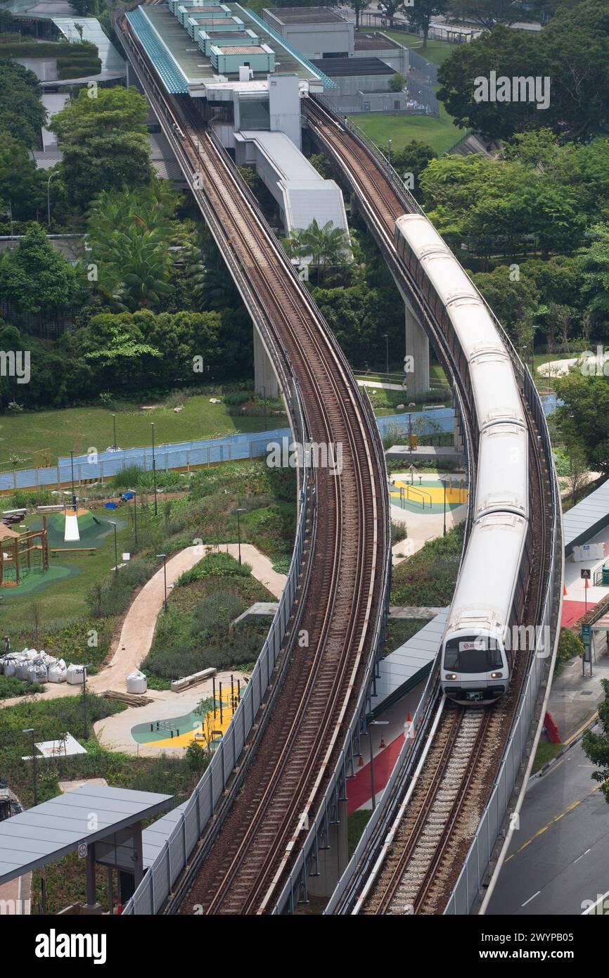 Vertical aerial view of a train leaving the station to the next stop ...