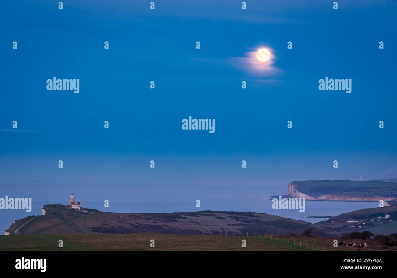 Full moon setting over Seaford Head and Belle Tout lighthouse on the ...