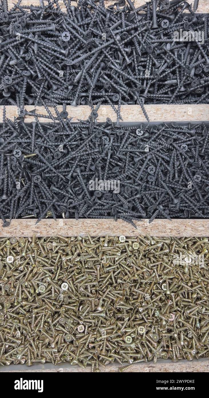 Black self-tapping screws in the store on the counter Stock Photo - Alamy