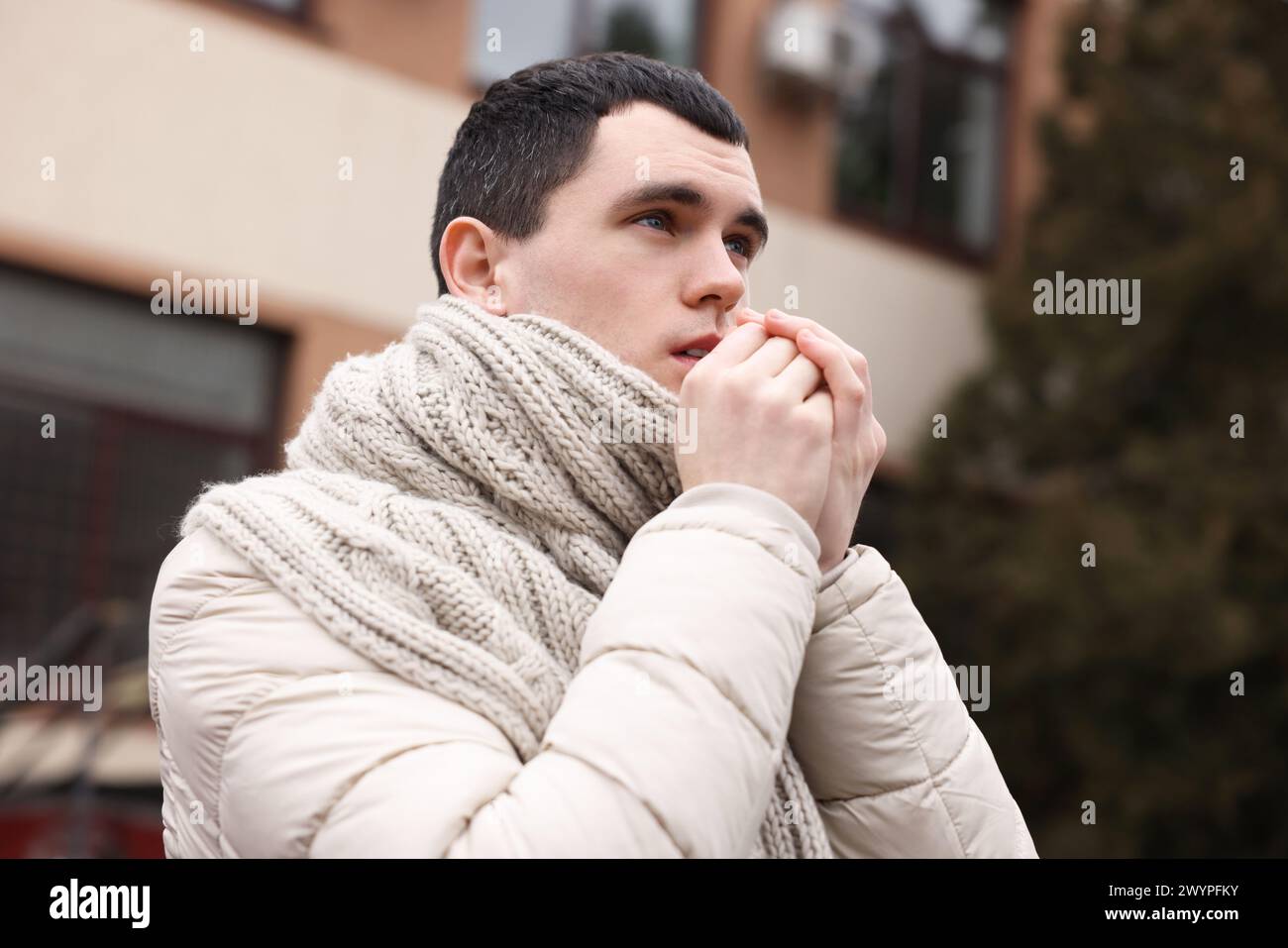 Sick young man coughing on city street. Cold symptoms Stock Photo - Alamy