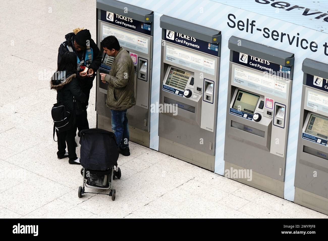 Passengers speak to a customer service adviser at Waterloo train ...