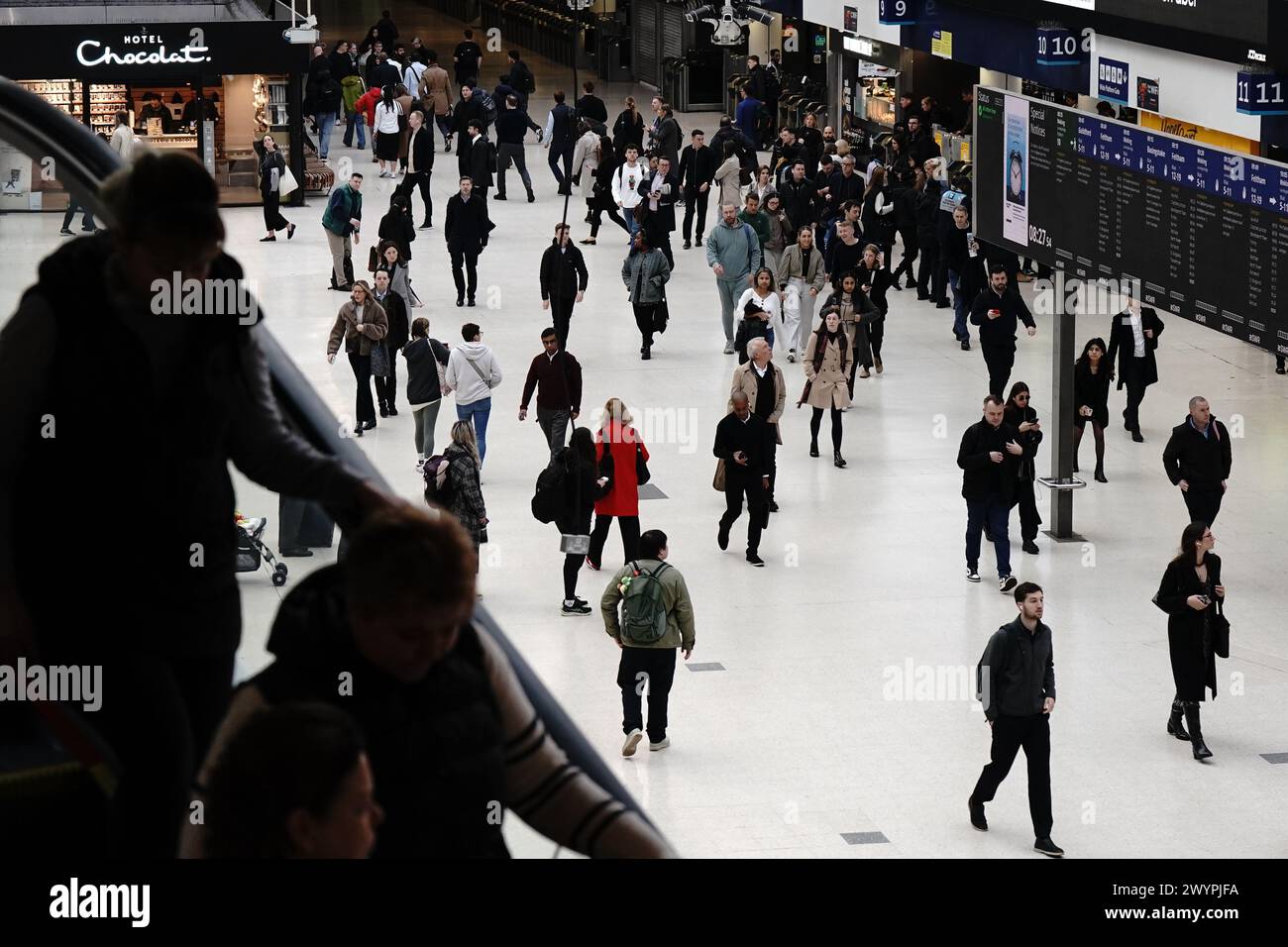 Passengers at Waterloo train station in London, as members of train ...