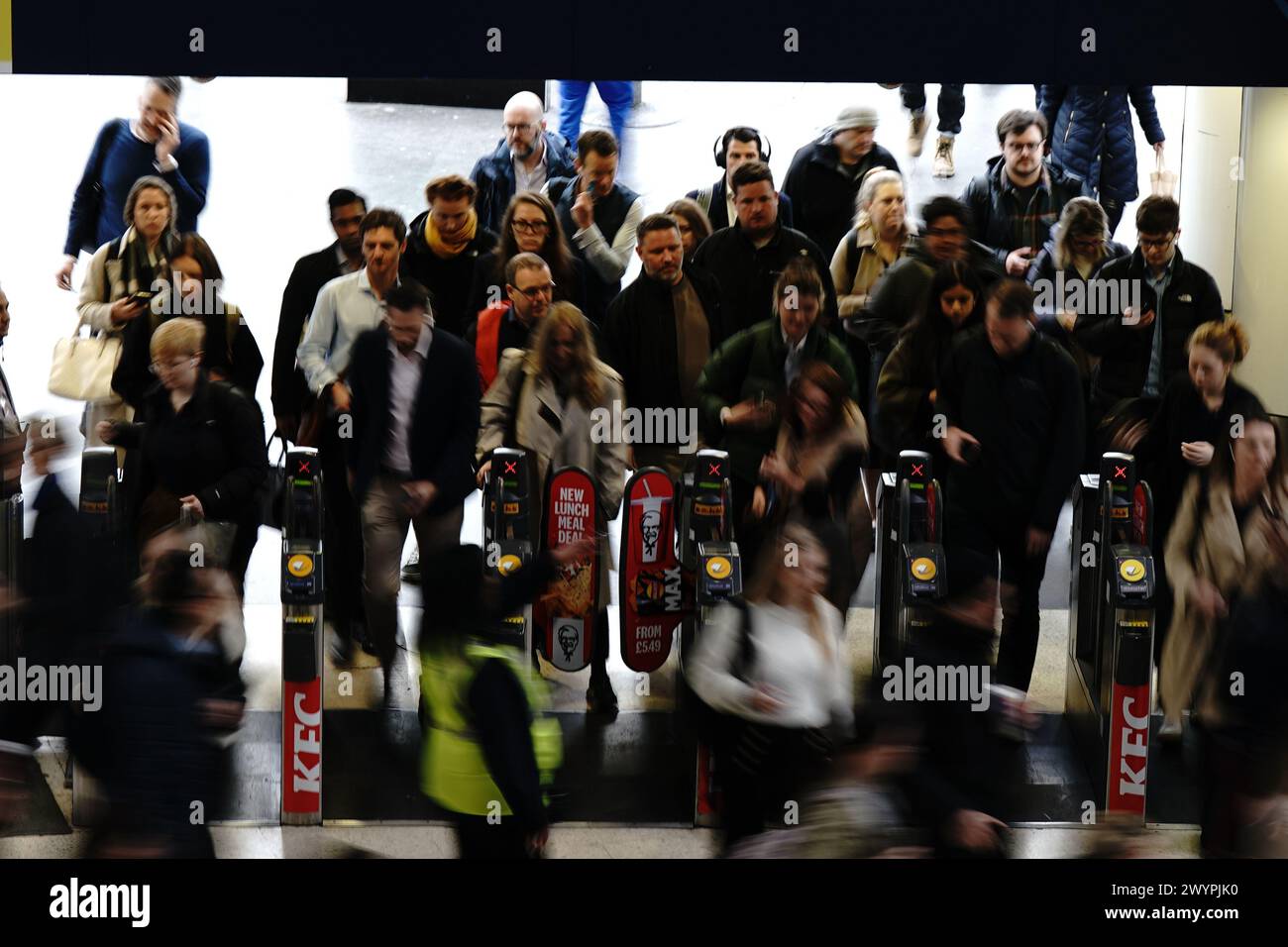 Passengers arrive at Waterloo train station in London, as members of ...