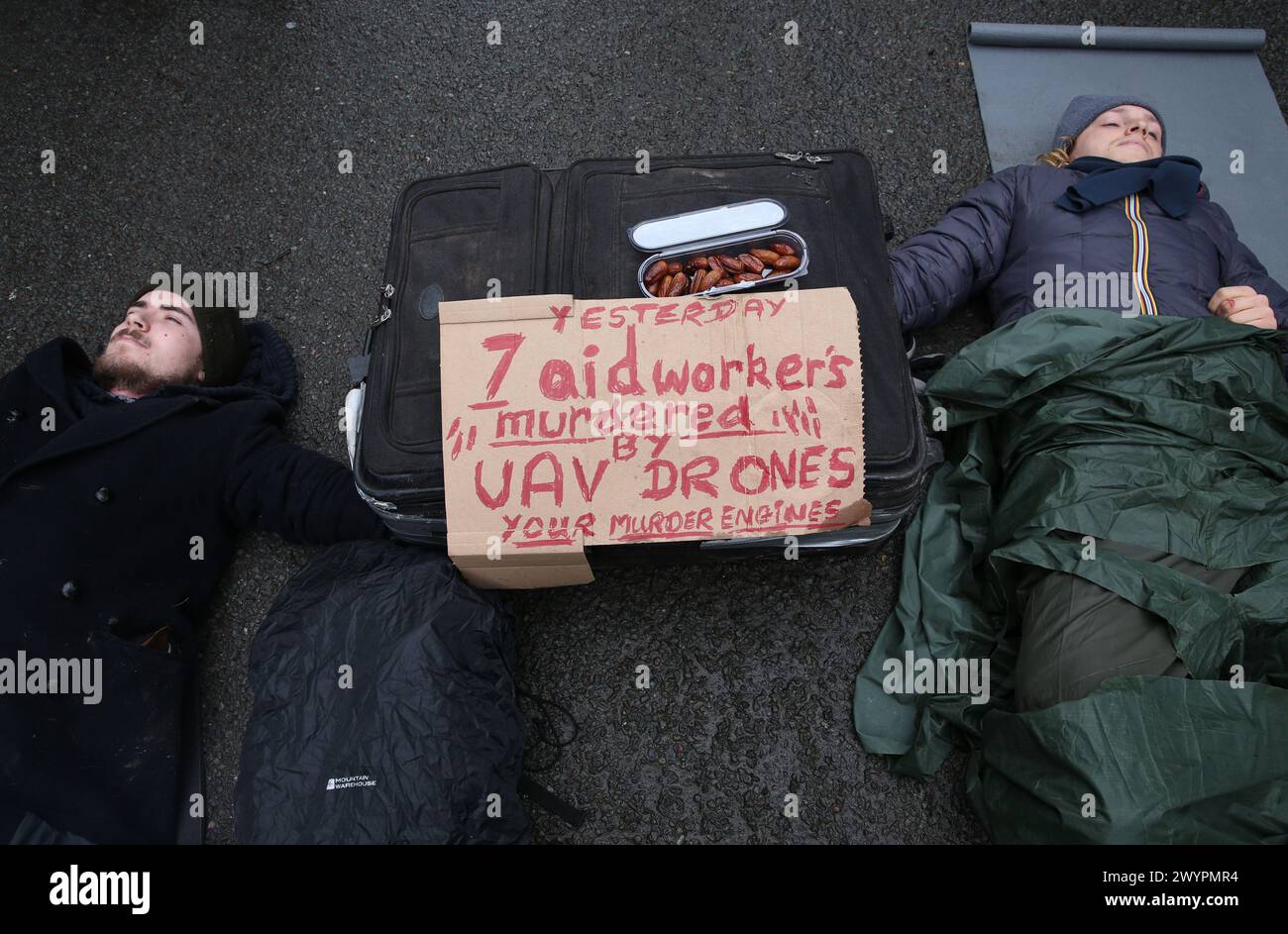 Activist support a sign accusing UAV Engines of supplying drone parts ...