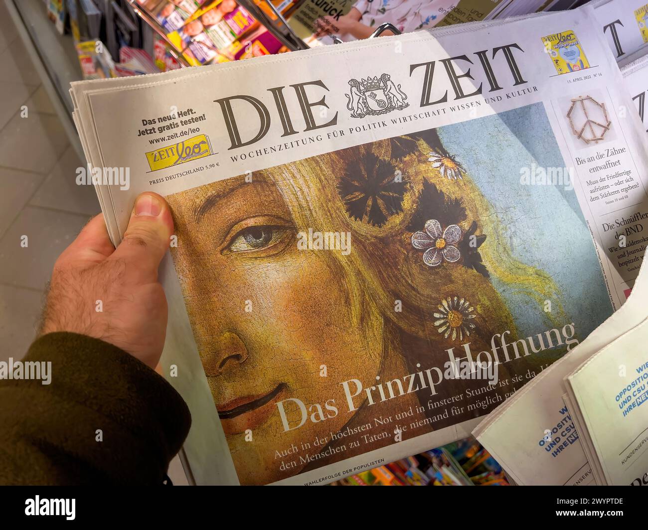 Frankfurt, Germany - Apr 14, 2022: A reader browses through DIE ZEIT, a ...