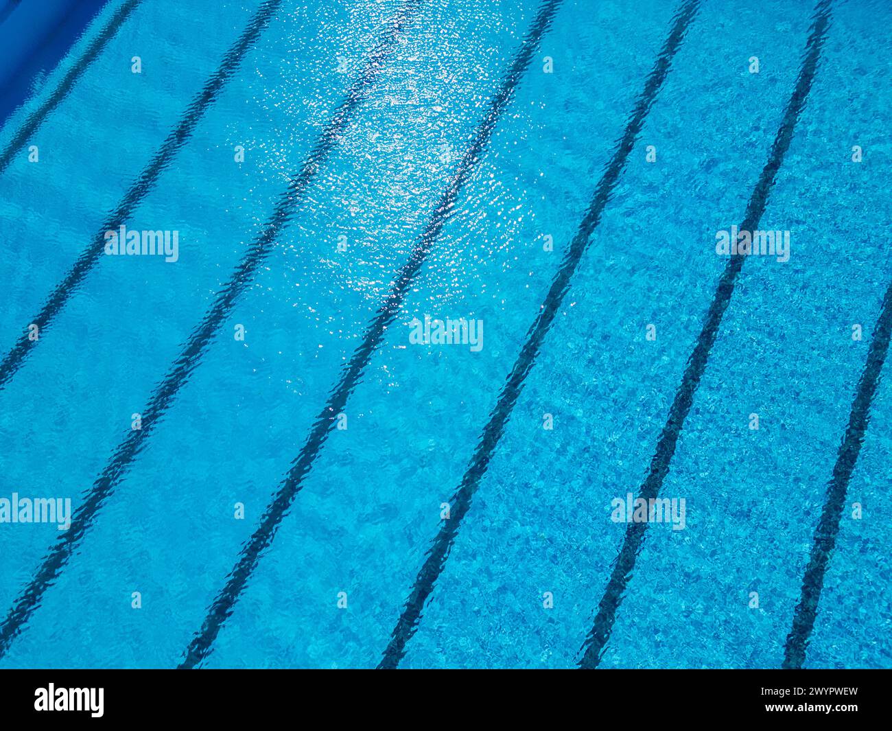 Sparkling Blue Swimming Pool With Sun Reflection Stock Photo - Alamy