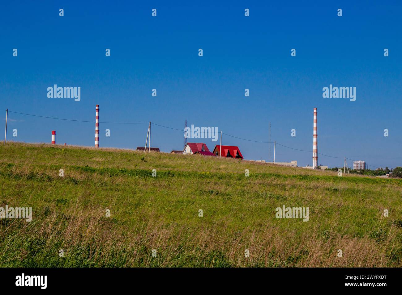 Clean field with rural and urban development on the horizon Stock Photo ...