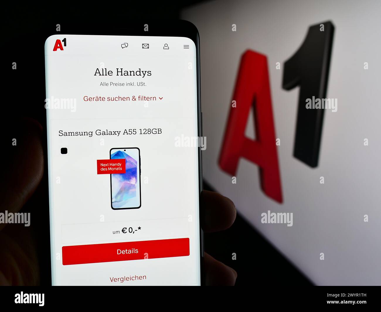 Person holding mobile phone with web page of telecommunications company ...