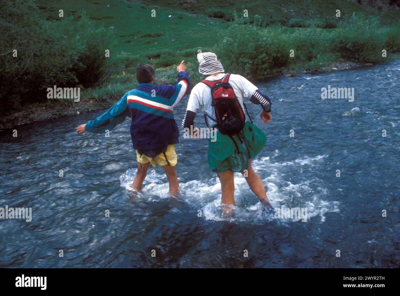 Runners cross a river in the hardrock 100. Billed as the toughest ...
