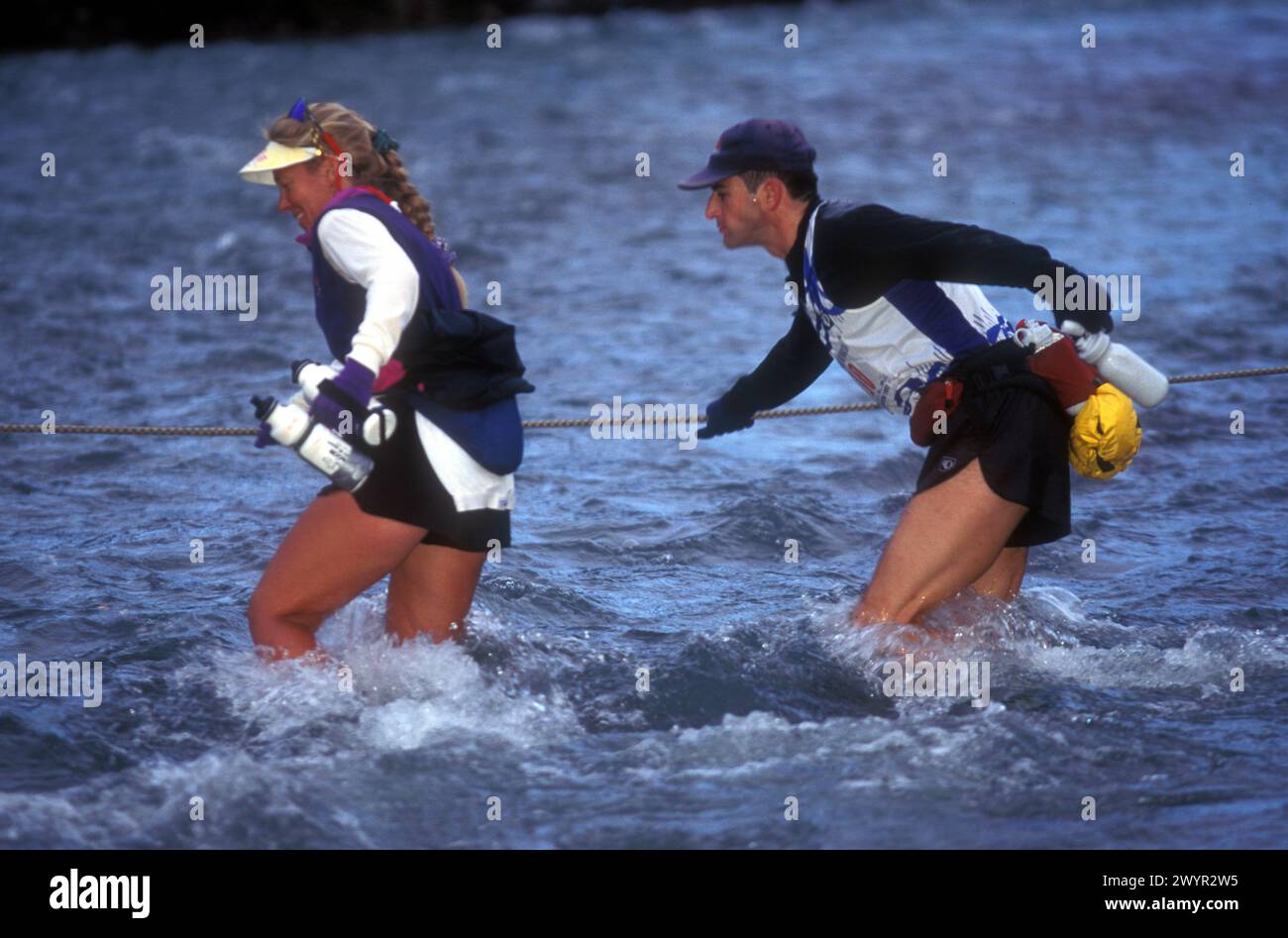 Runners cross a river in the hardrock 100. Billed as the toughest ...