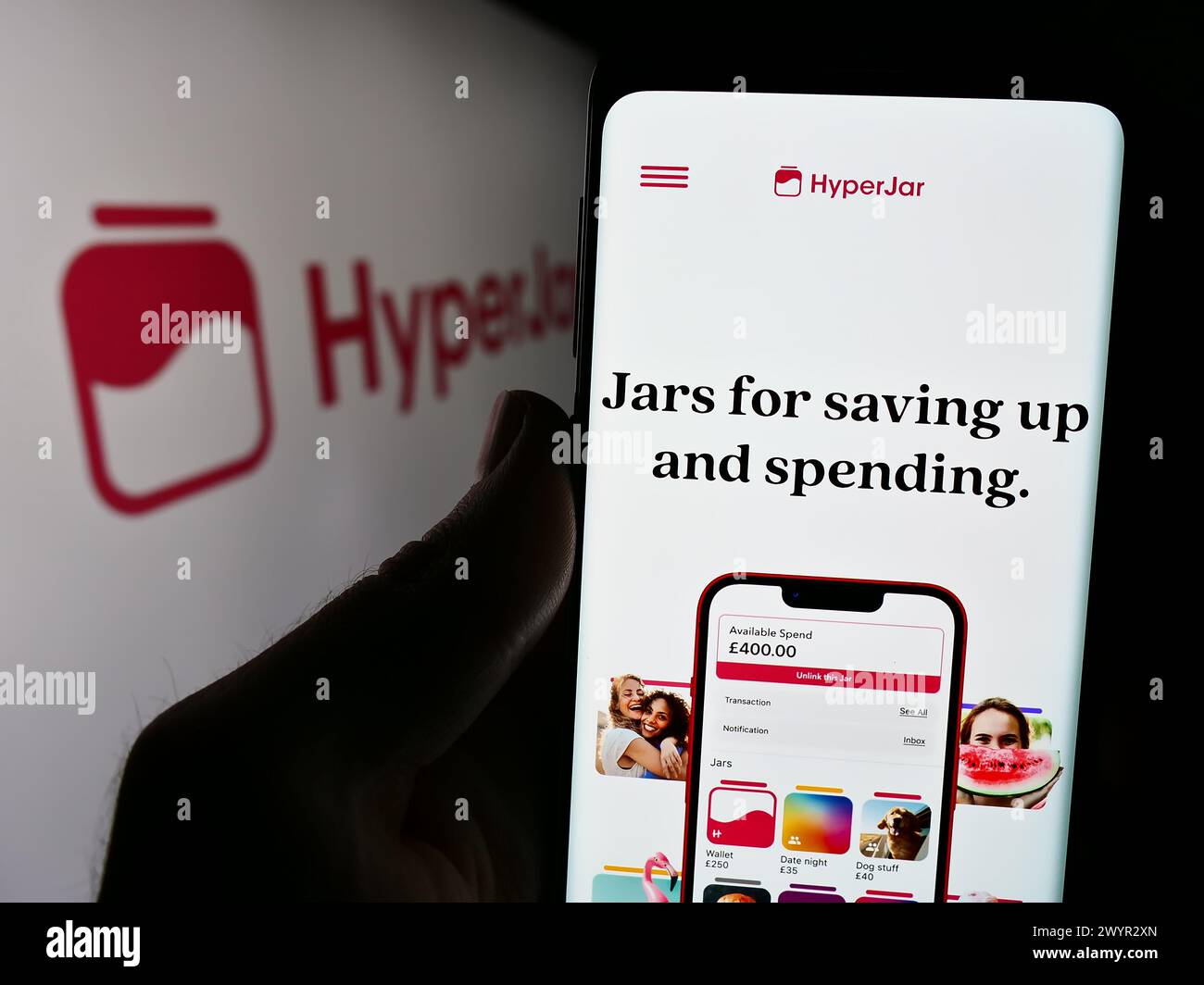 Person holding mobile phone with web page of British financial ...