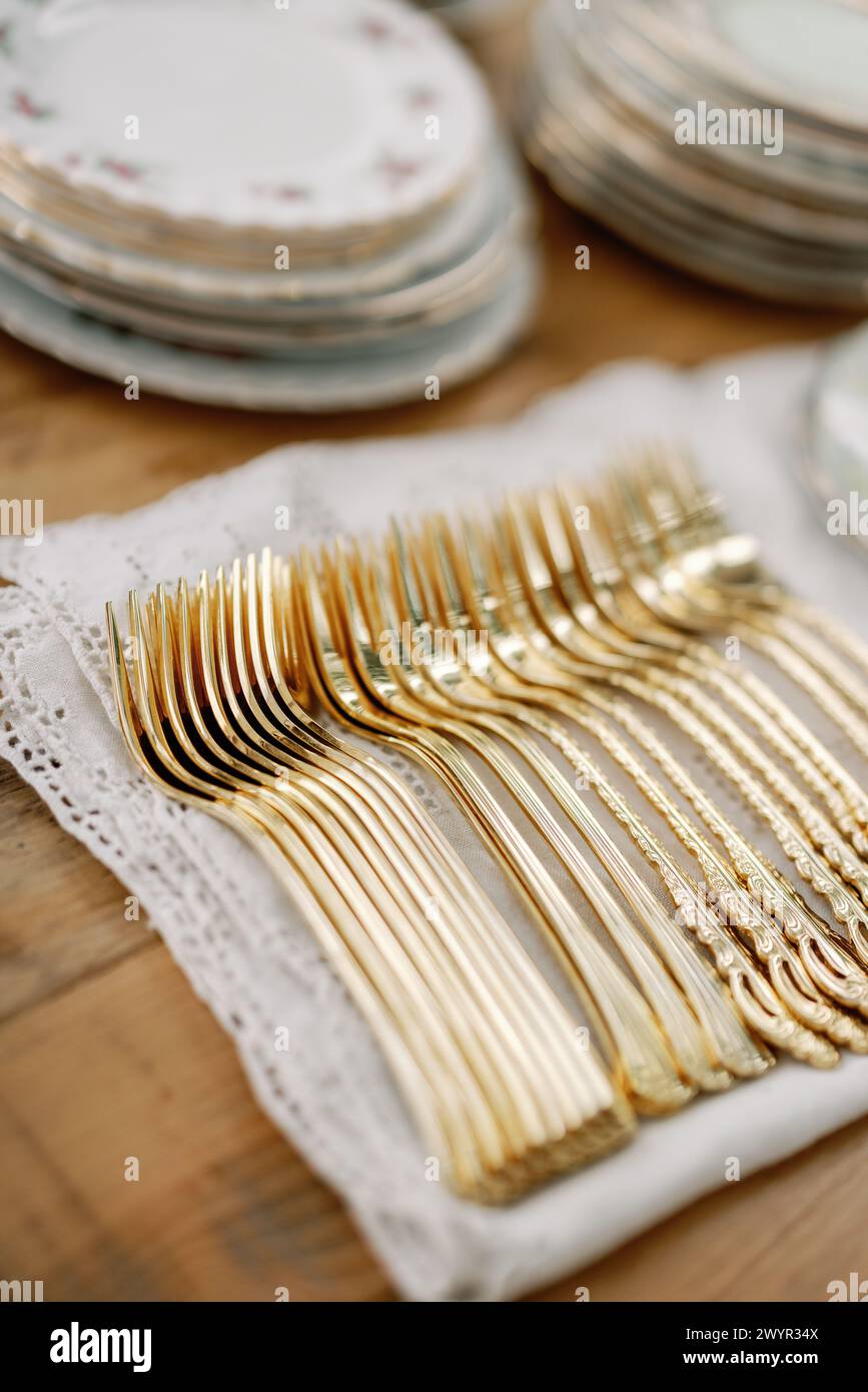 Elegant gold flatware on lace, table setting detail Stock Photo - Alamy