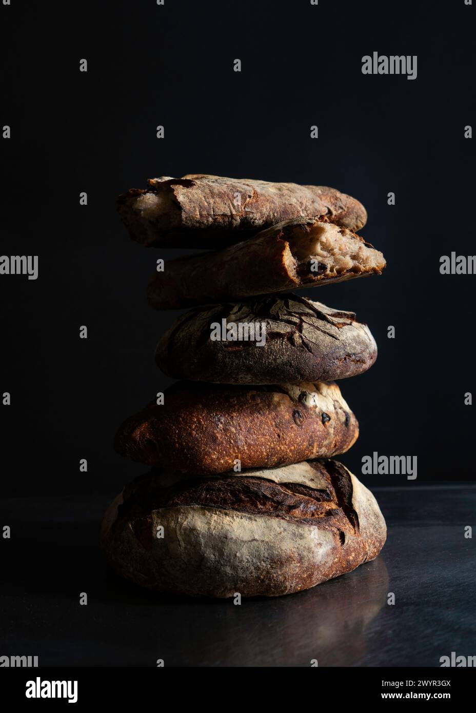 Stacked loaves of baked bread vertical Stock Photo - Alamy